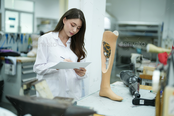 Orthopedic technician making prosthetic leg for disabilities people in workshop. Stock Photo by ...